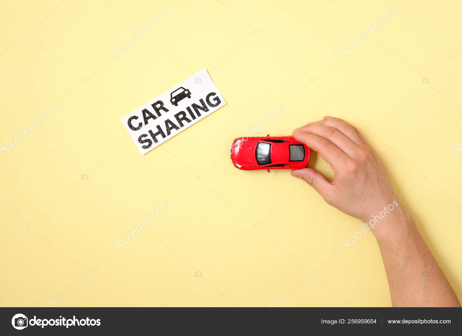 Car sharing concept. Human hand is driving red toy car model to text ...