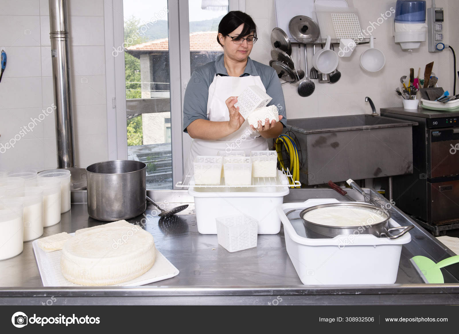 Cheesemaker turns the shapes of fresh cheese Stock Photo by ...
