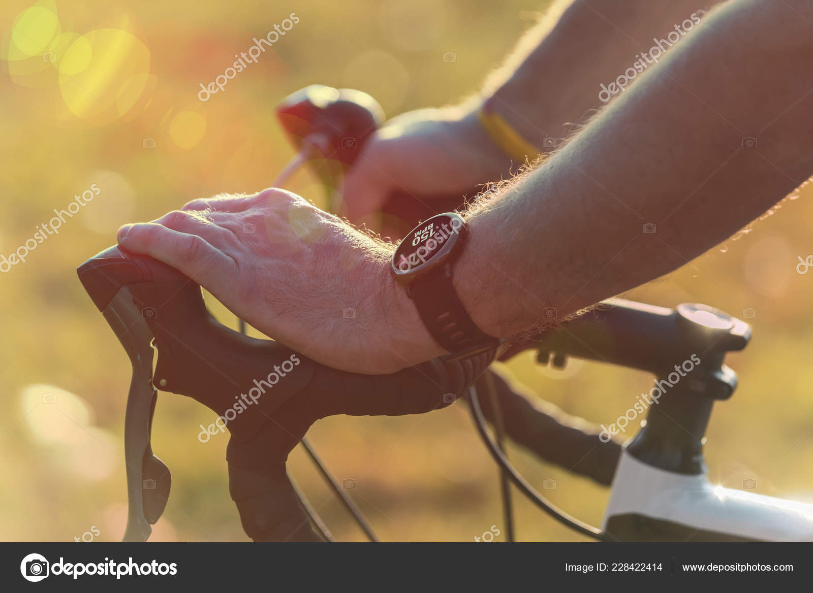 Man riding a bike with smartwatch heart rate monitor Stock Photo by ...