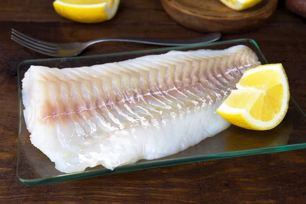 raw fillet of cod ready to be cooked in rustic wood - Stock Image ...