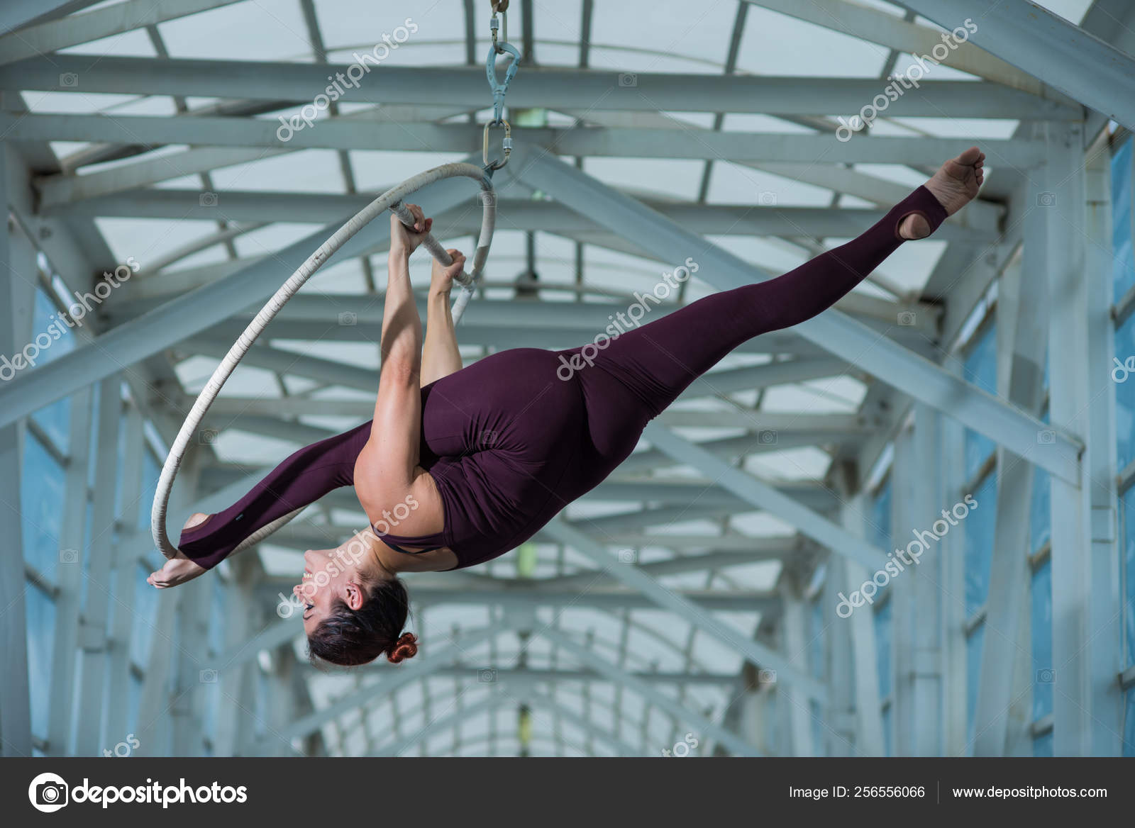 An air gymnast makes a Russian splits on an air hoop suspended on a ...