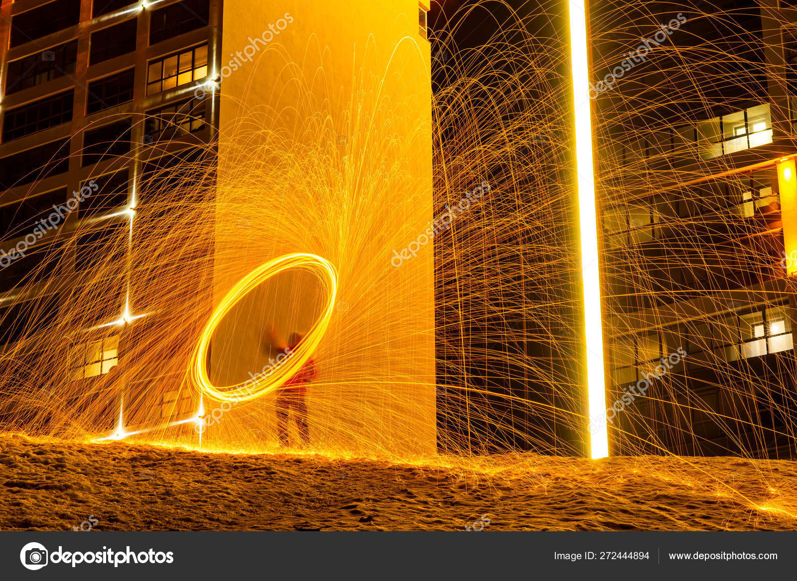 Large round burning fireworks sparkle from the burning steel wool. The ...