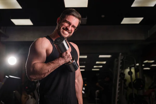 A man with an effort does an exercise for biceps and triceps with a ...