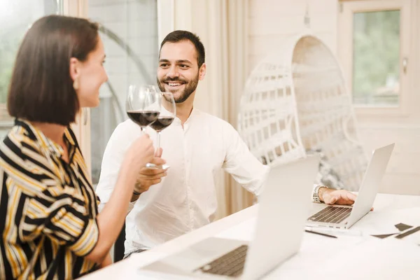 Young business people work on improving the taste of wine. Plans and ...