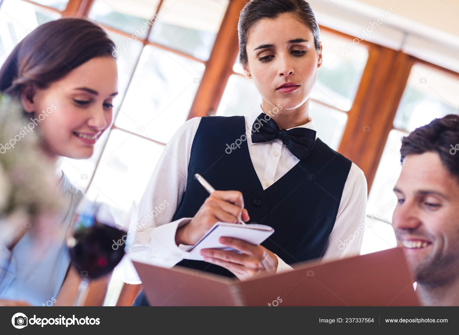Waiters And Waitresses Taking Orders