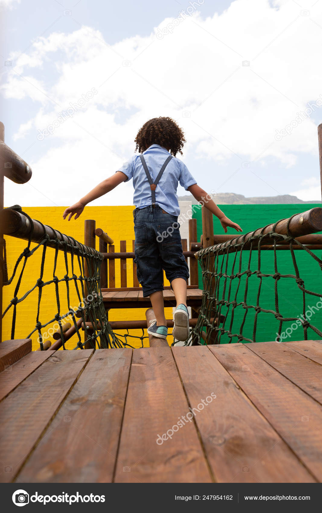 Rear View Mixed Race Schoolboy Walking Net Bridge School Playground ...