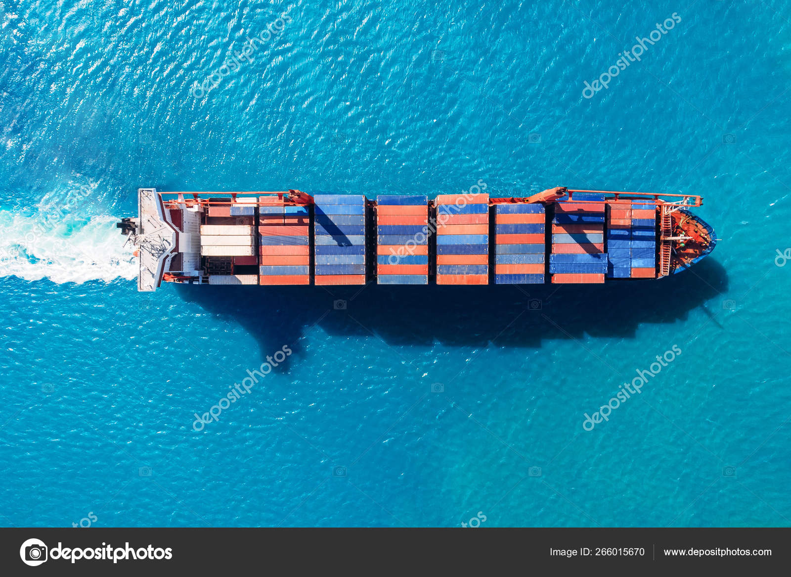 Cargo ship with containers against the blue sea, top view aerial ...