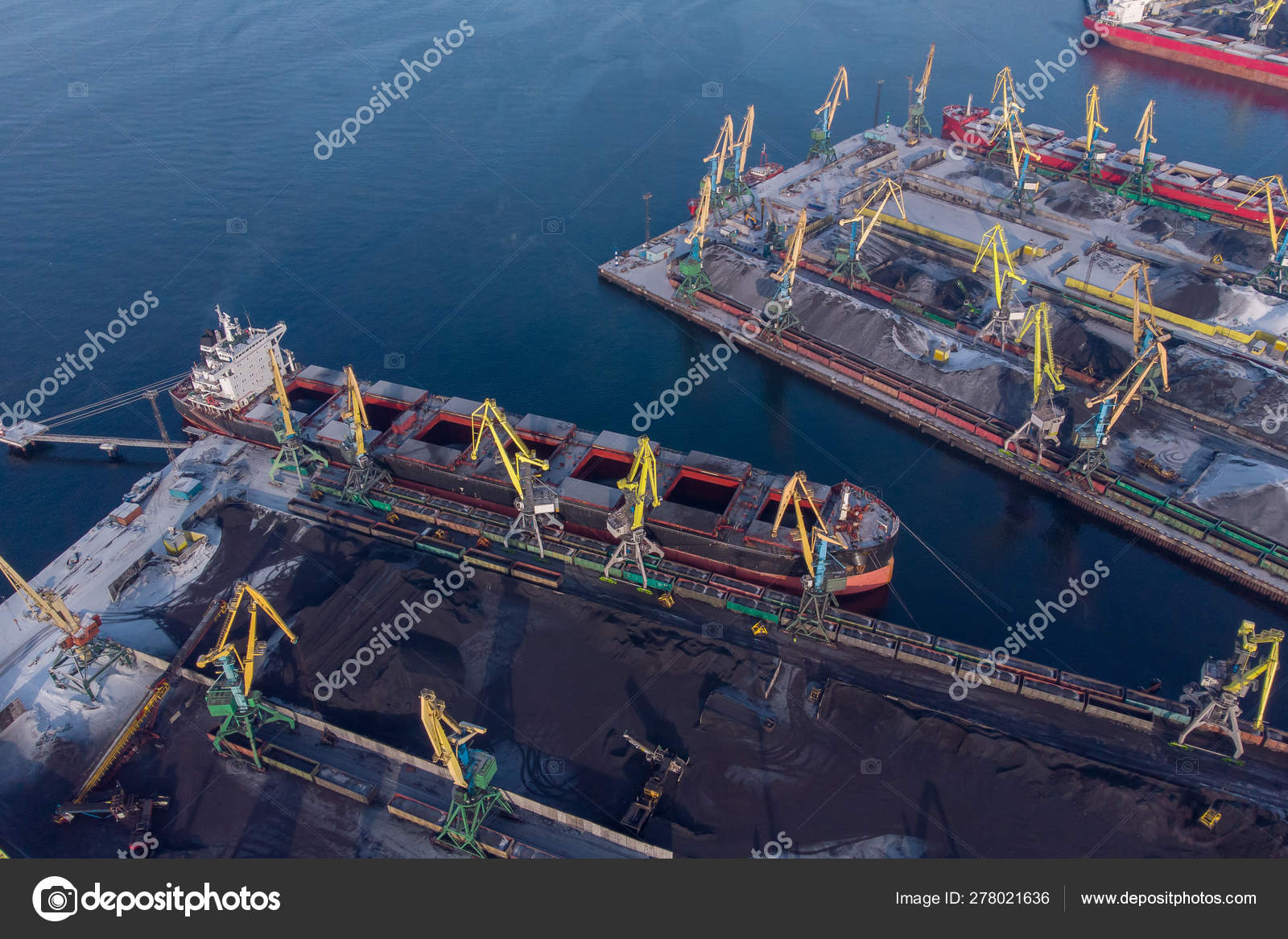 Loading coal mining in port on cargo tanker ship with crane bucket of ...