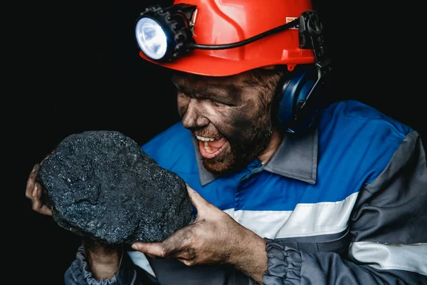 Miner angry man screams and frowns, holds sheet of paper for text ...