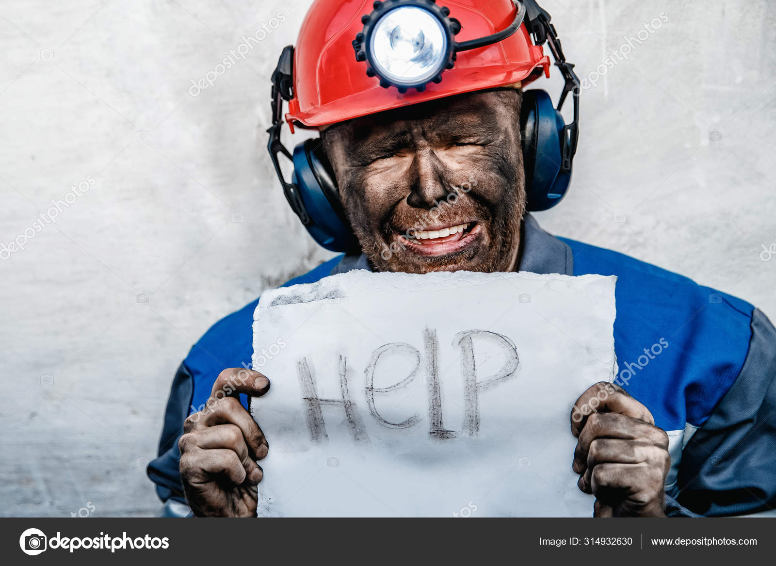 Miner angry man screams and frowns, holds sheet of paper for text ...