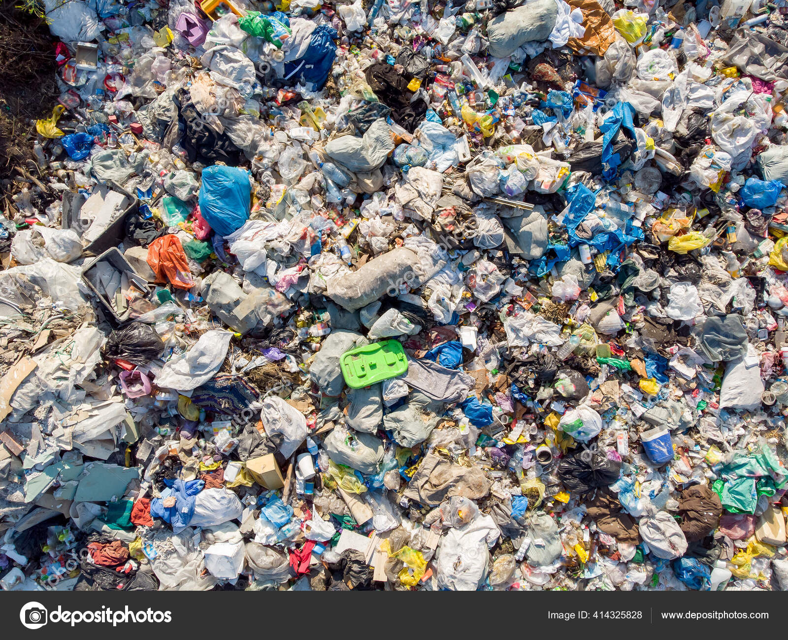 Land pollution with plastic bottles and bags. Open storage of solid ...