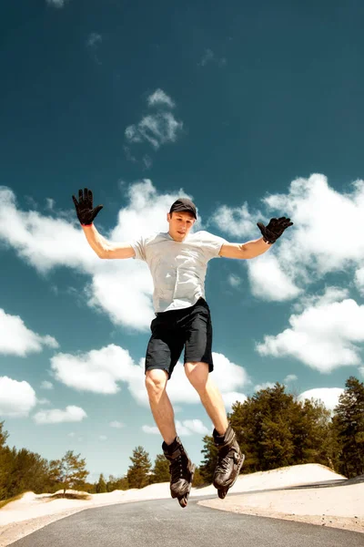 Aggressive inline skating. Young athlete performs tricks during ...
