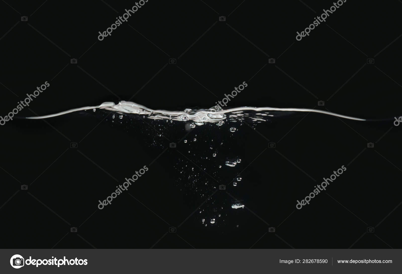 Waving water surface and small bubbles underwater isolated on black ...