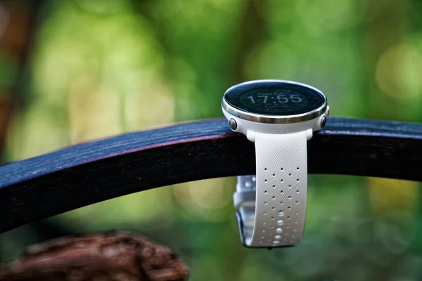 Sport watch for running white color on wooden bench. Fitness watch for ...