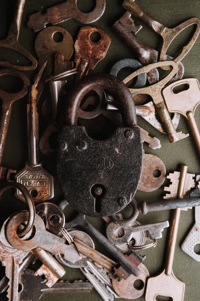 aged iron padlock in center and keys aroun - Stock Image - Everypixel