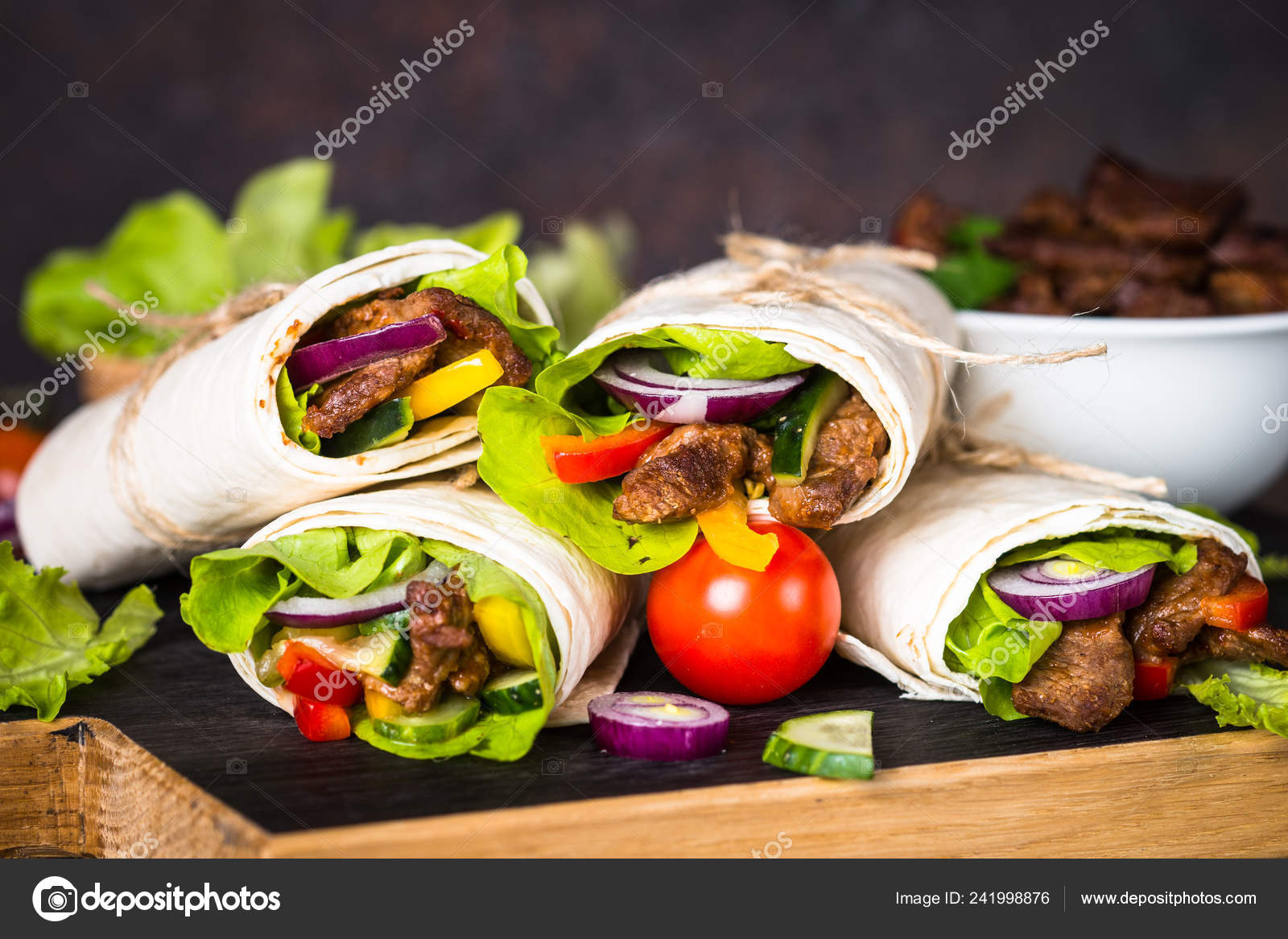 Burritos tortilla wraps with beef and vegetables. Stock Photo by ...