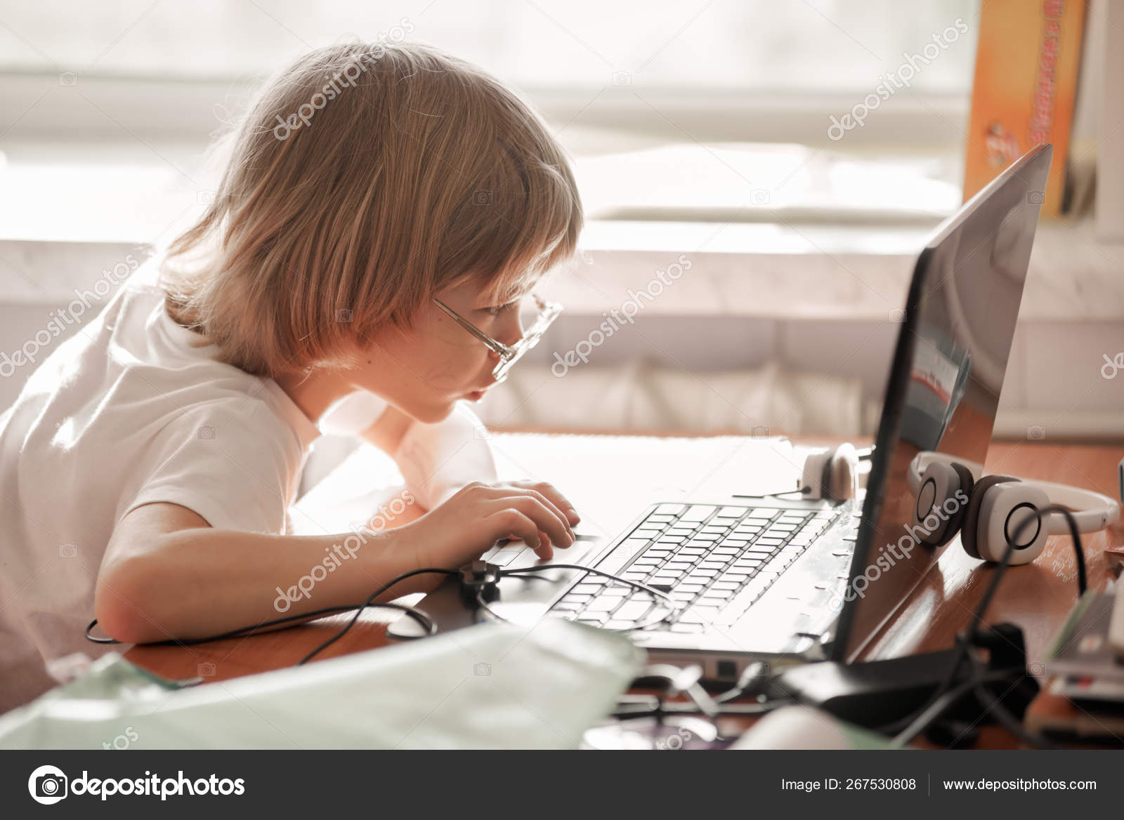 Boy studying with laptop Stock Photo by ©seenaad 267530808
