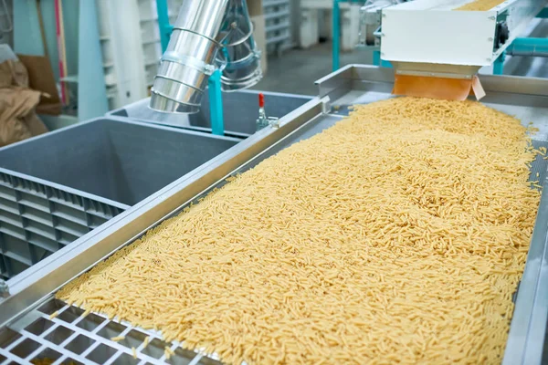 Crop shot of production process at modern food factory, focus on ...