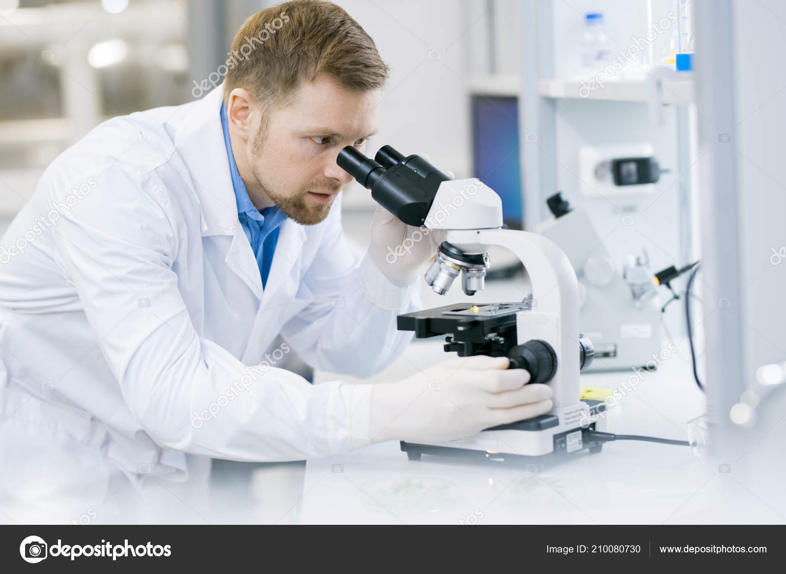 Person Looking Through Microscope