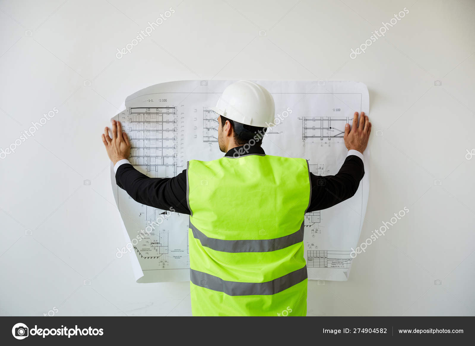 Back View Portrait Middle Eastern Engineer Holding Plans Wall While ...