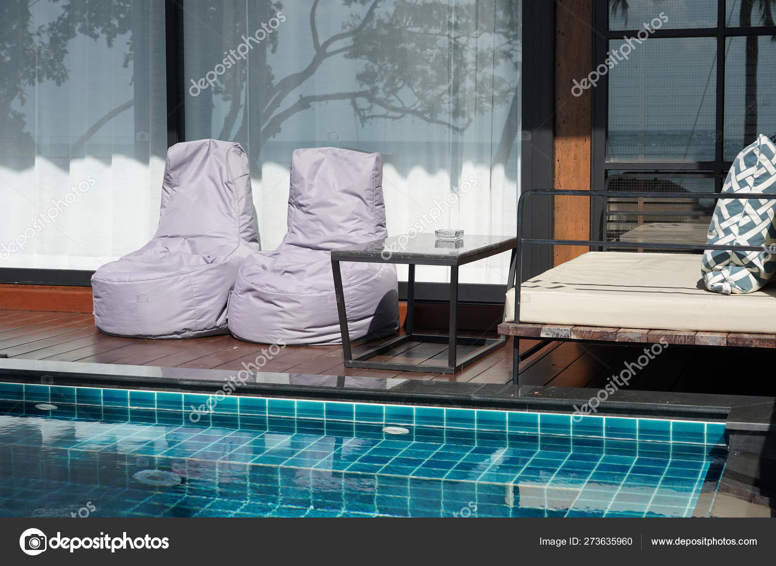 Rest zone near swimming pool in a tropical hotel near summer beach in ...