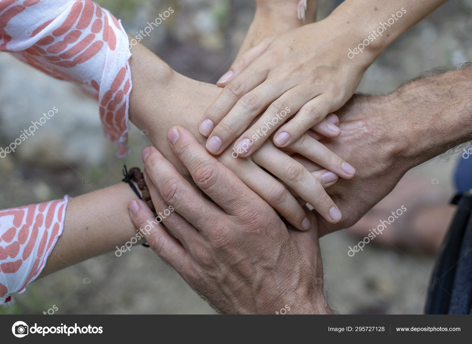Many hands getting together in the center of a circle. Close up outdoor ...