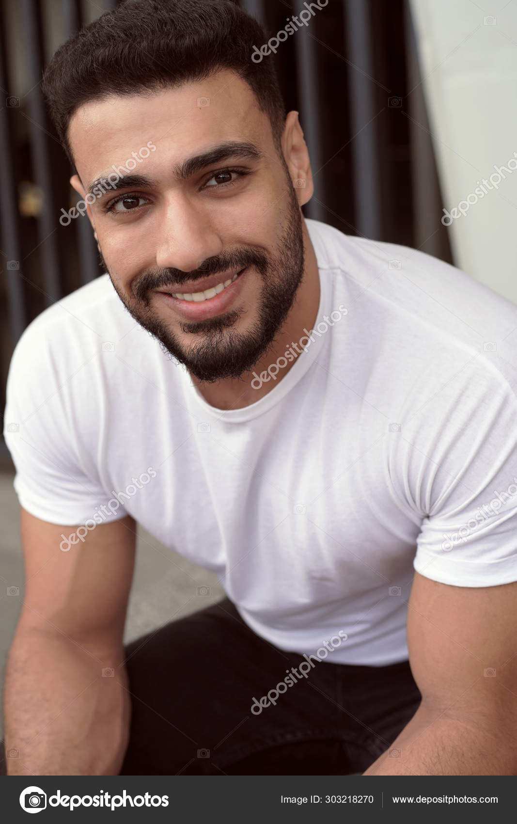 Young Handsome Man Sitting Looking Camera Smiling Wearing Basic White ...