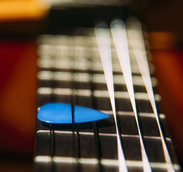 guitar worn frets and blue pick under the strings - Stock Image ...