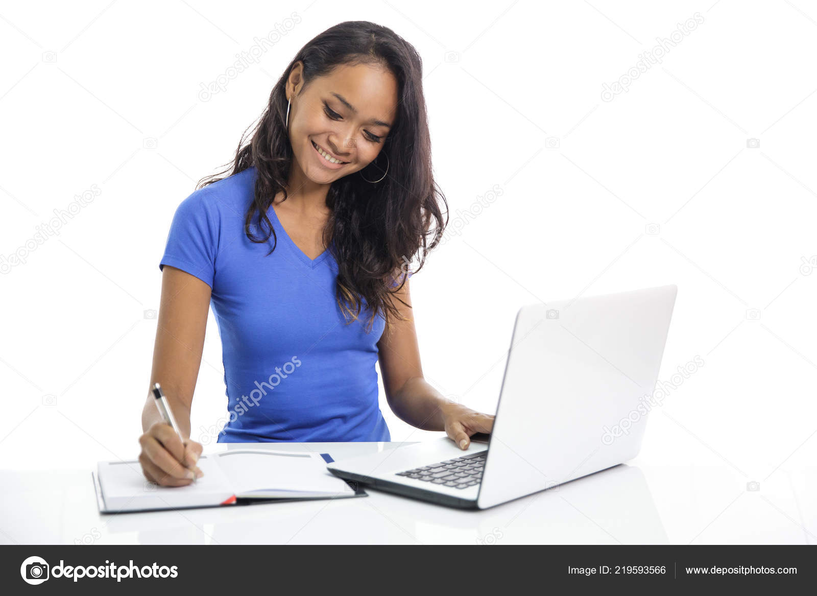 Beautiful casual college student writing on a notebook while bro ...