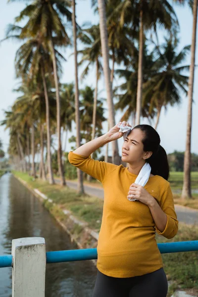 maternity woman take a break after workout outdoor - Stock Image ...