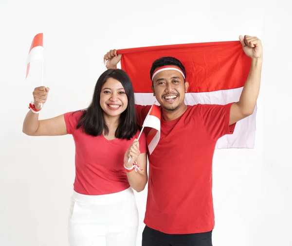Four friends together holding indonesian flag celebrating independence ...