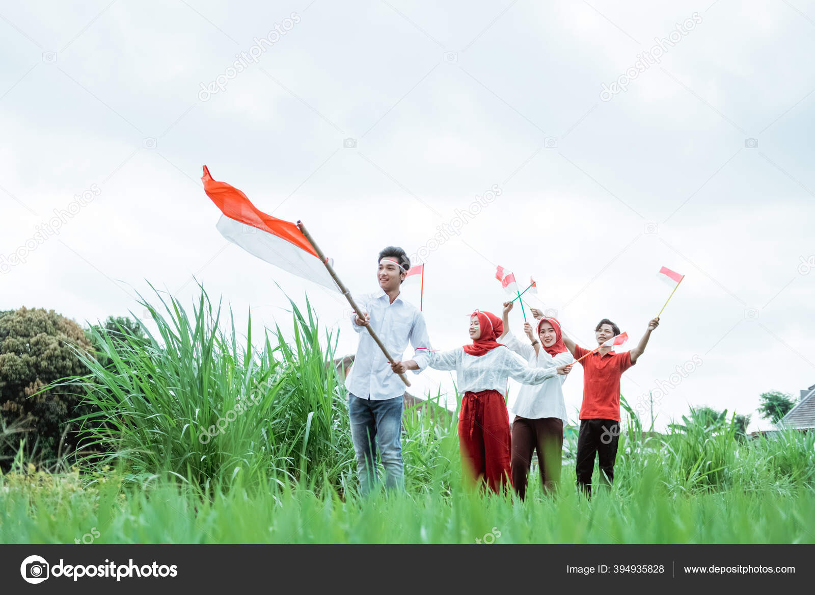 Asian young man in white walking carrying an Indonesian flag and his ...