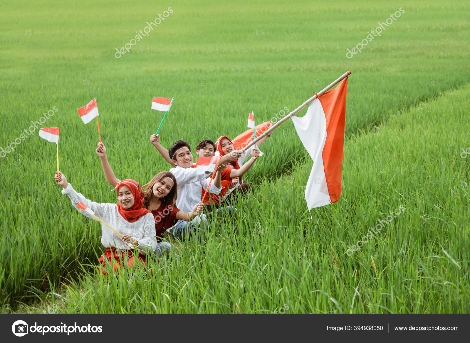 Having fun together of young people march on the rice field hold ...
