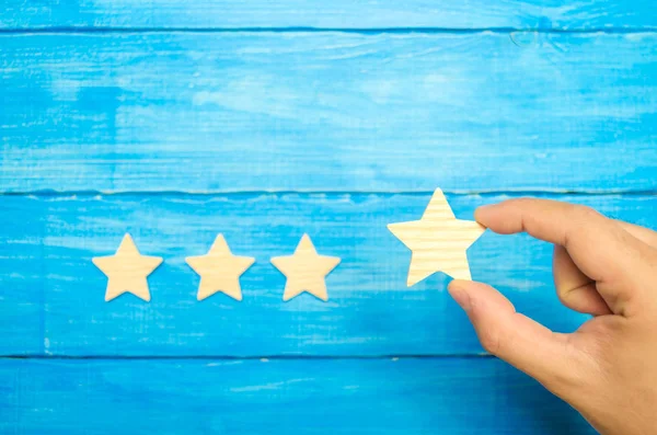 The businessman's hand in the suit holds the fourth star. Get the star ...