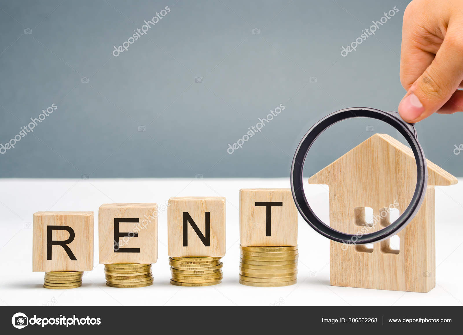 Magnifying glass, wooden blocks with the word Rent, coins and a ...