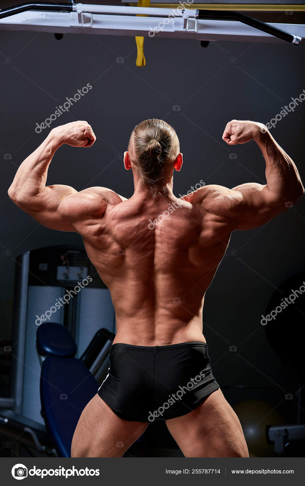 Athletic man posing. Photo of man with perfect physique on black ...
