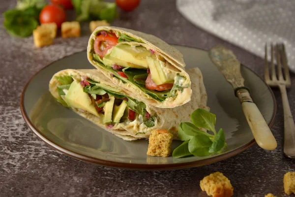 Tortilla wraps with avocado, cherry tomato. Healthy, vegan food. Take ...