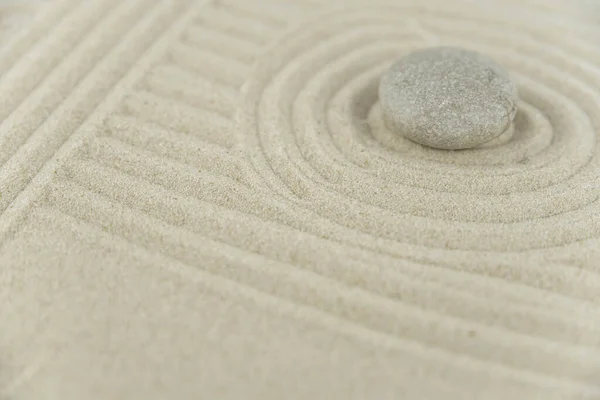 Zen garden. Pyramids of white and gray zen stones on the white sand ...