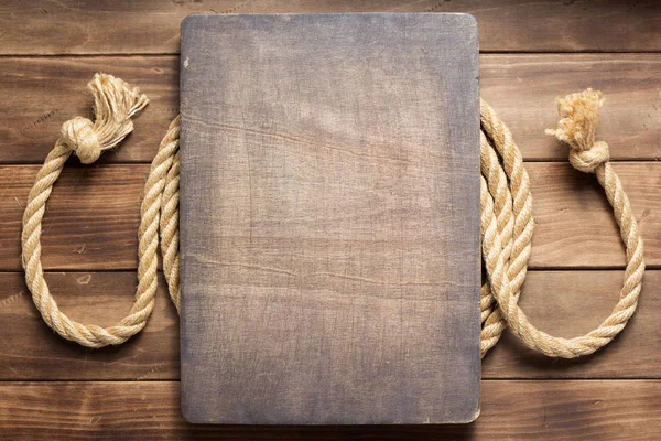 Wooden board with ship rope Stock Photo by ©axesor 68775513