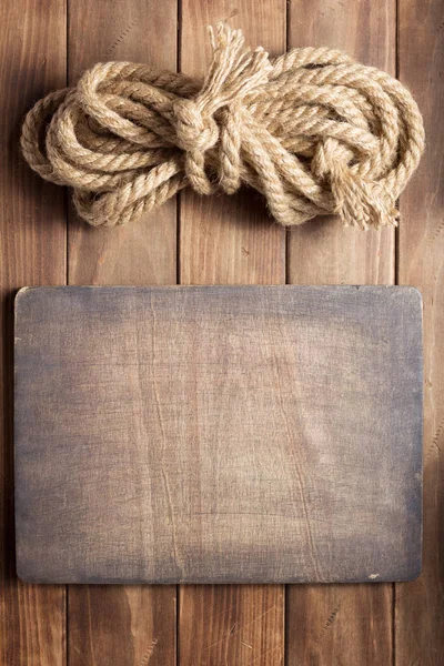Wooden board with ship rope Stock Photo by ©axesor 68775513