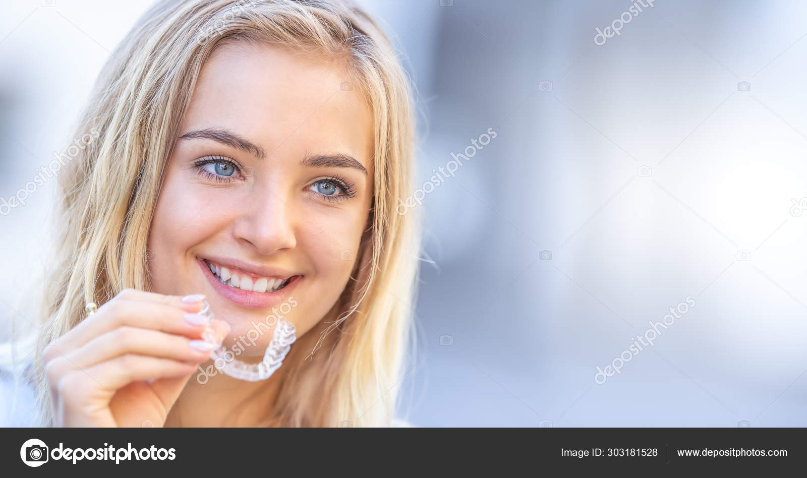 Invisalign orthodontics concept - Young attractive woman holding Stock ...
