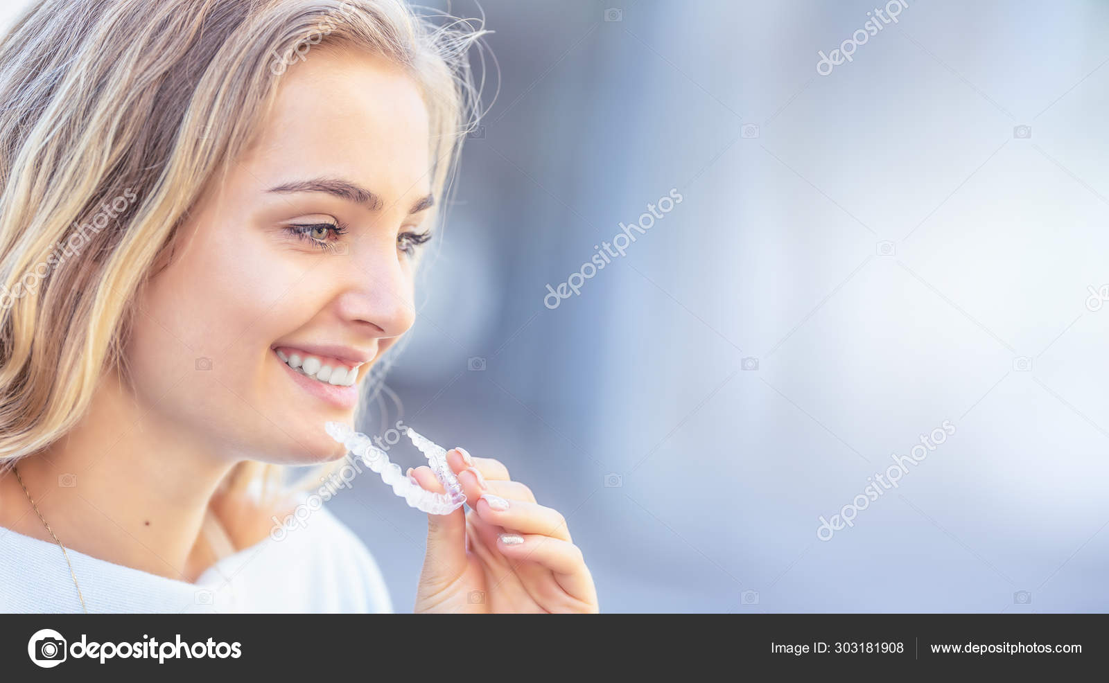 Invisalign orthodontics concept - Young attractive woman holding Stock ...
