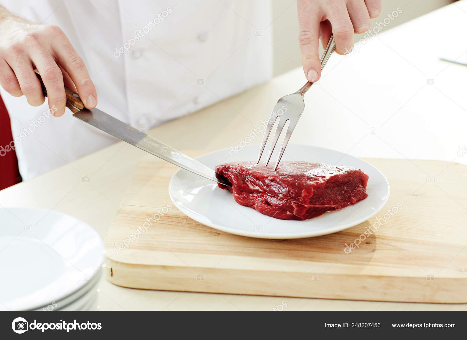 Download - Close-up of unrecognizable chef checking raw meat slice and ...