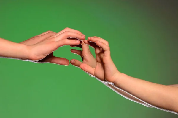 Two hands stretch to each other from the opposite sides symbolizing the ...