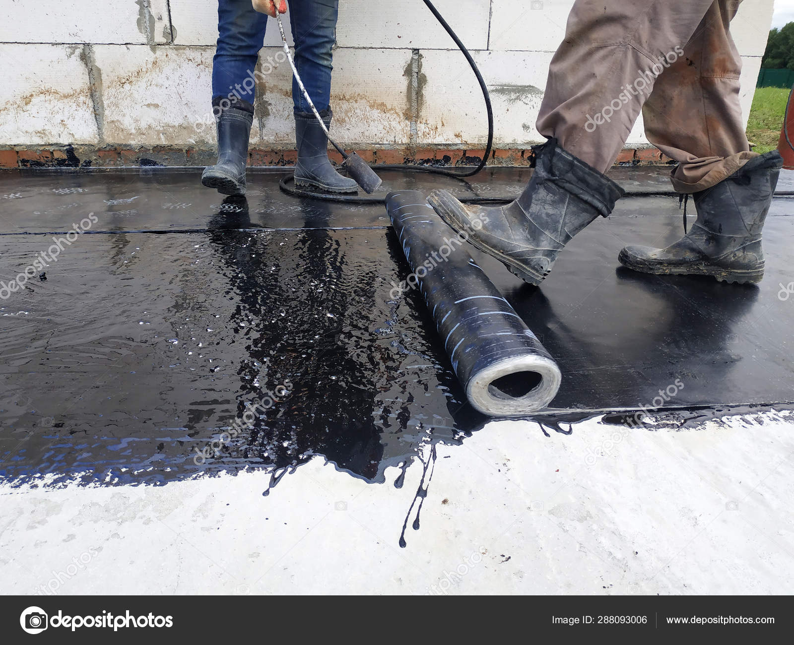 Worker covered surface, bitumen primer for improving adhesion during ...