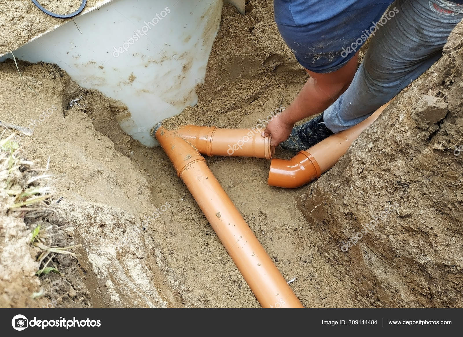 The contractor installs a sewer in a ditch and leads the pipe to the ...