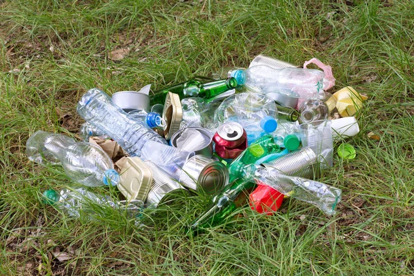 Rubbish such as plastic and glass bottles, tins, cans and pieces of ...