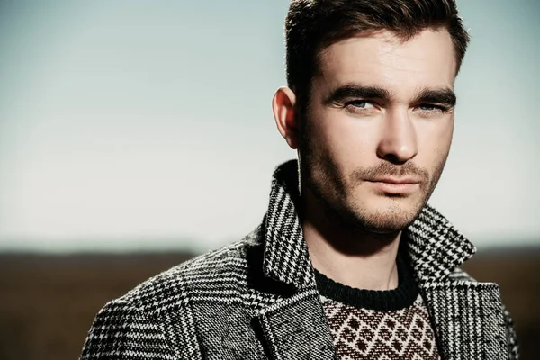 A portrait of a handsome man in countryside. Spring fashion for men ...