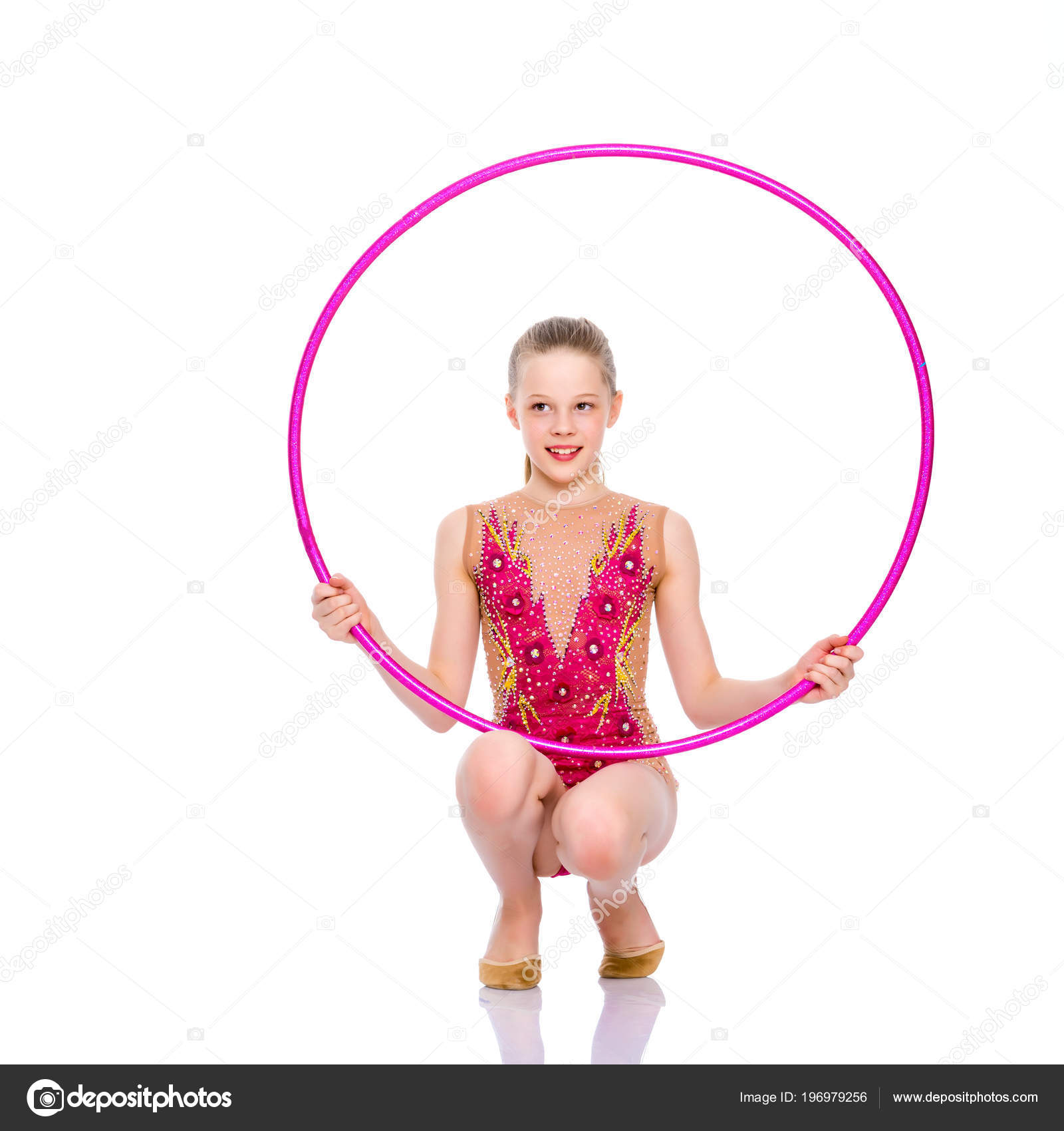 A girl gymnast performs an exercise with a hoop. Stock Photo by ...