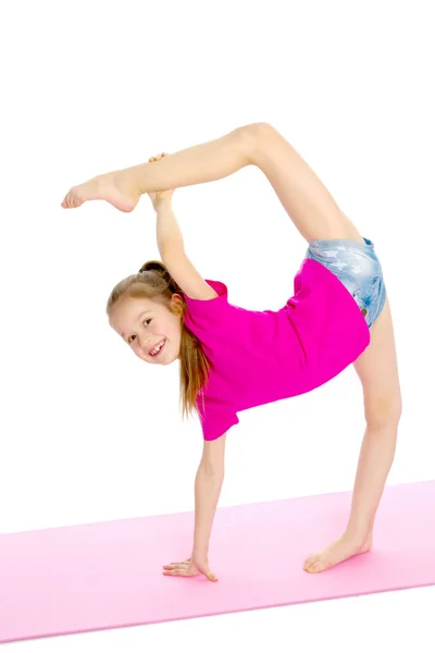 The little gymnast perform an acrobatic element on the floor. Stock ...